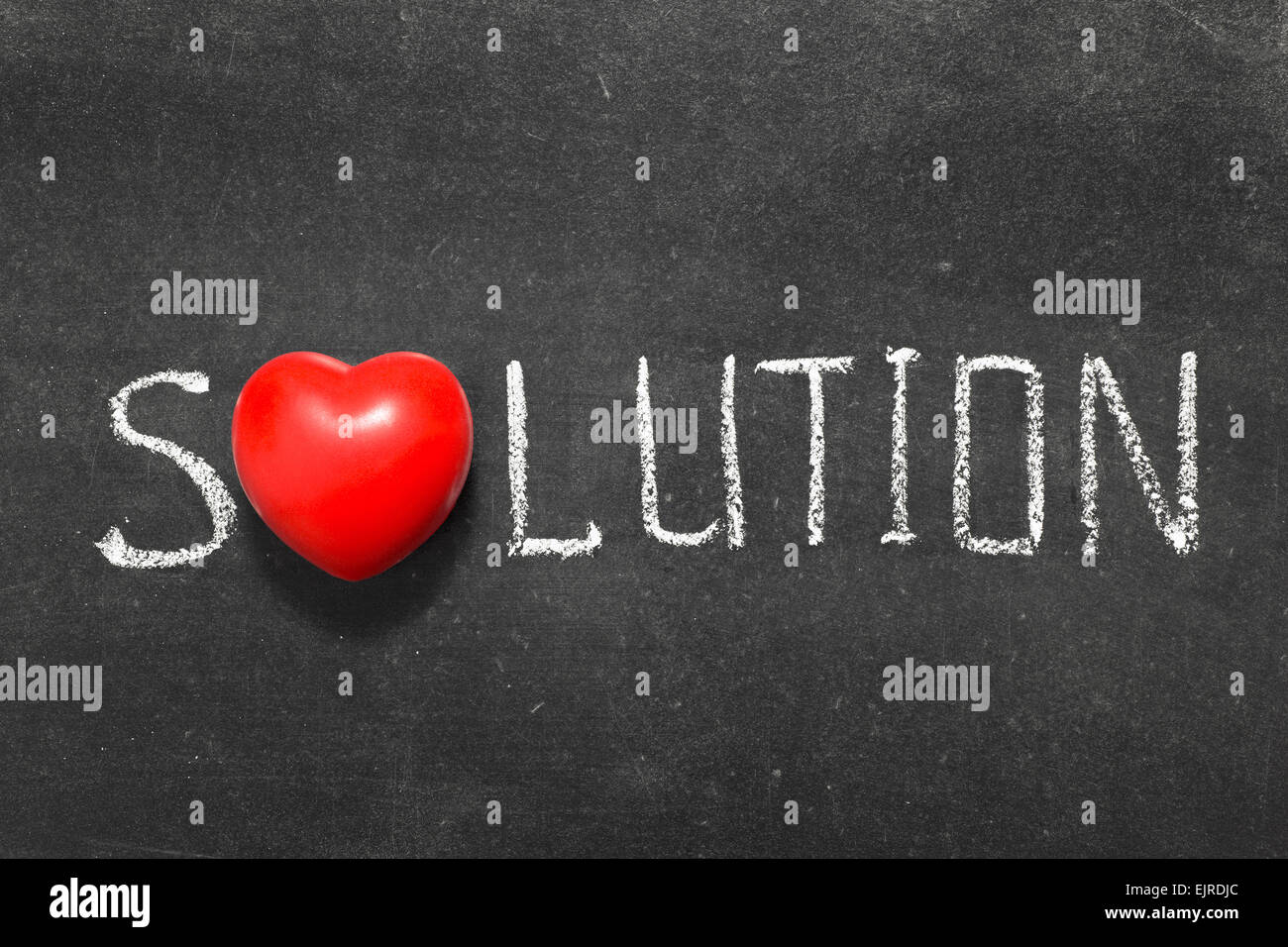solution word handwritten on blackboard with heart symbol instead of O ...