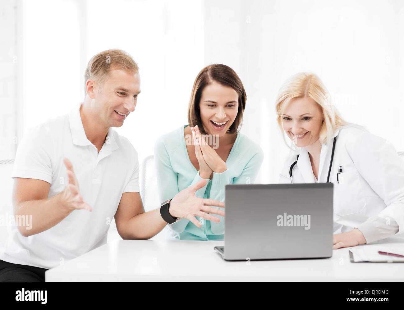 doctor with patients looking at laptop Stock Photo - Alamy