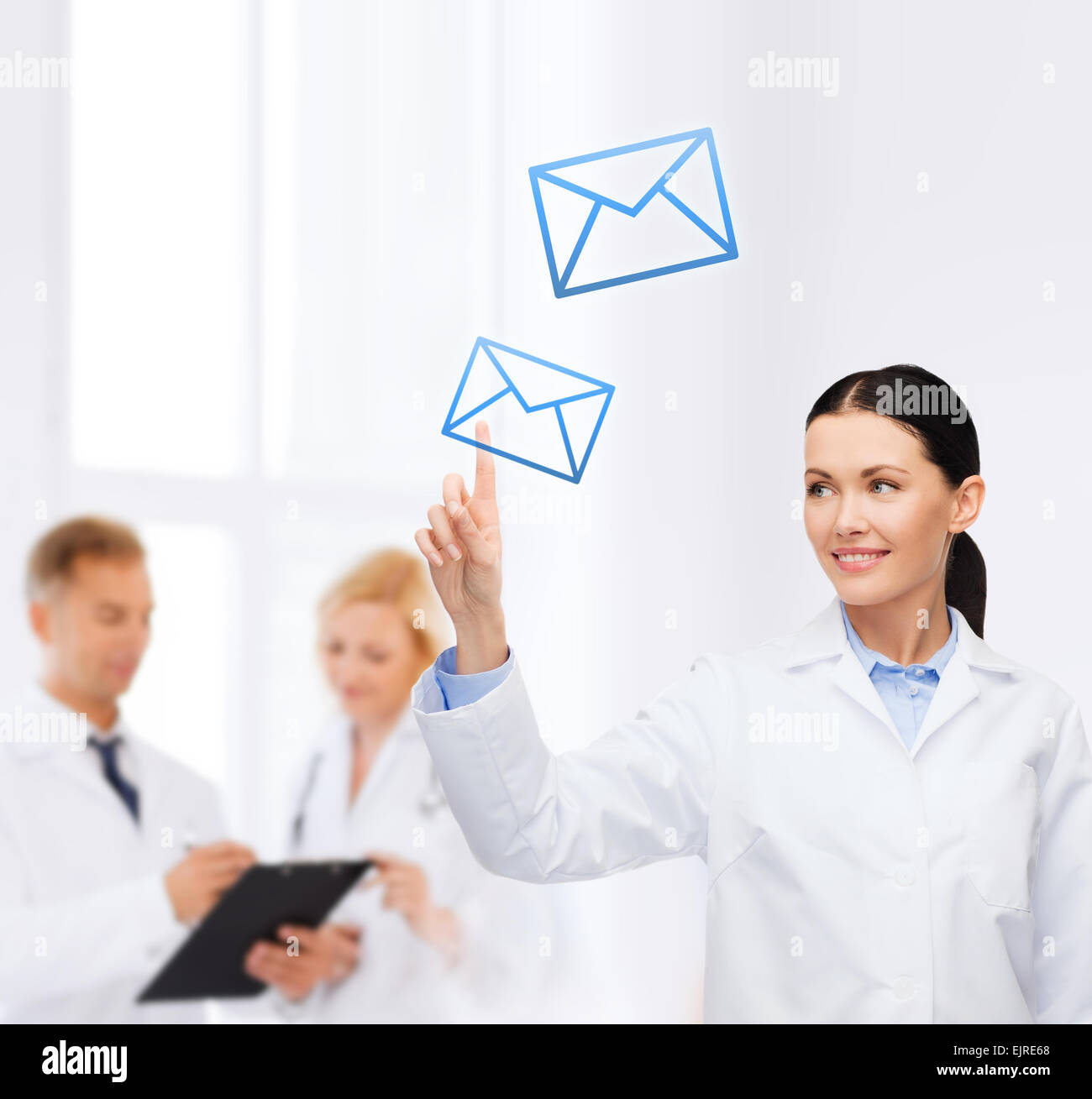 smiling female doctor pointing to envelope Stock Photo - Alamy