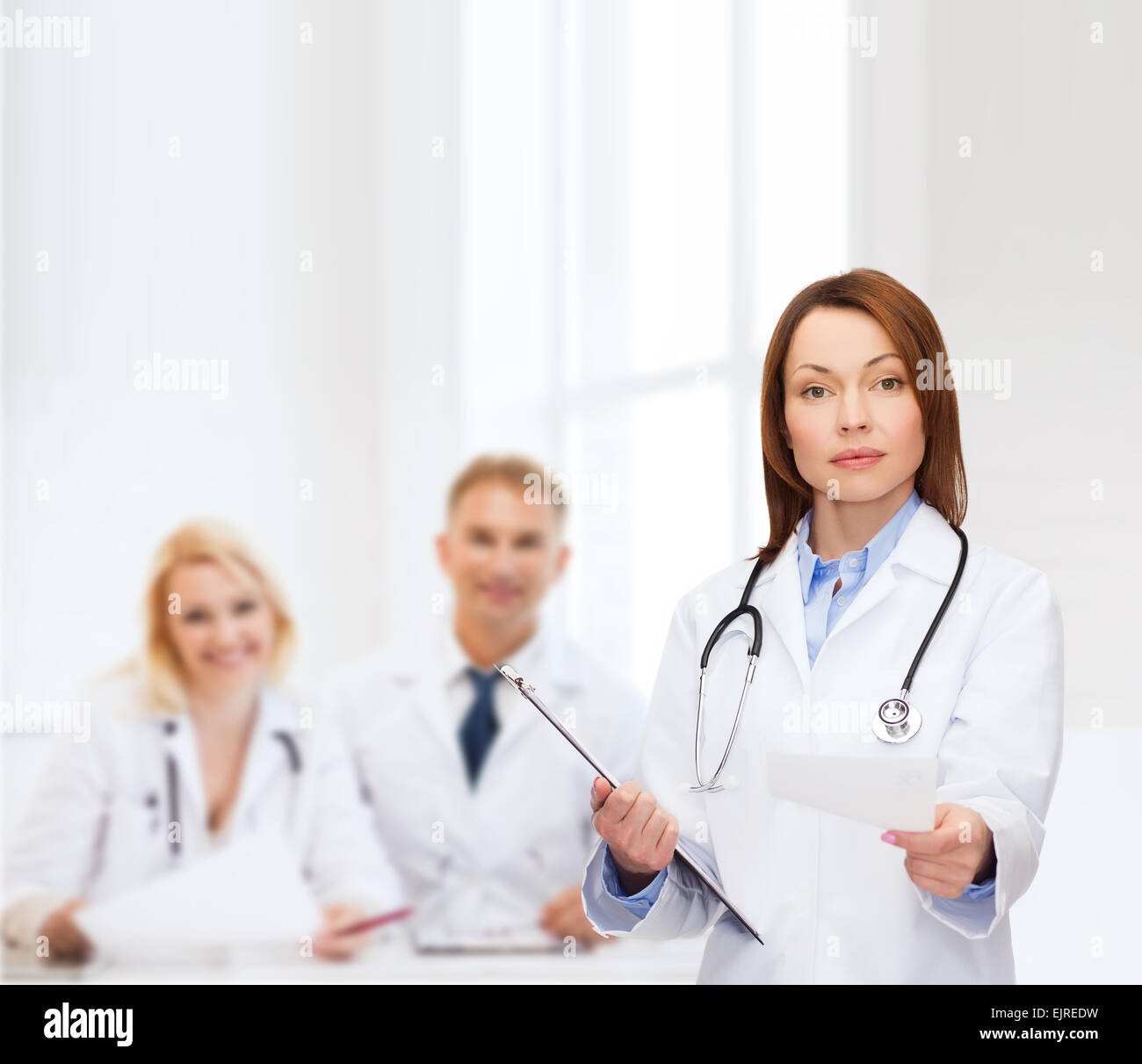 calm female doctor with clipboard Stock Photo - Alamy