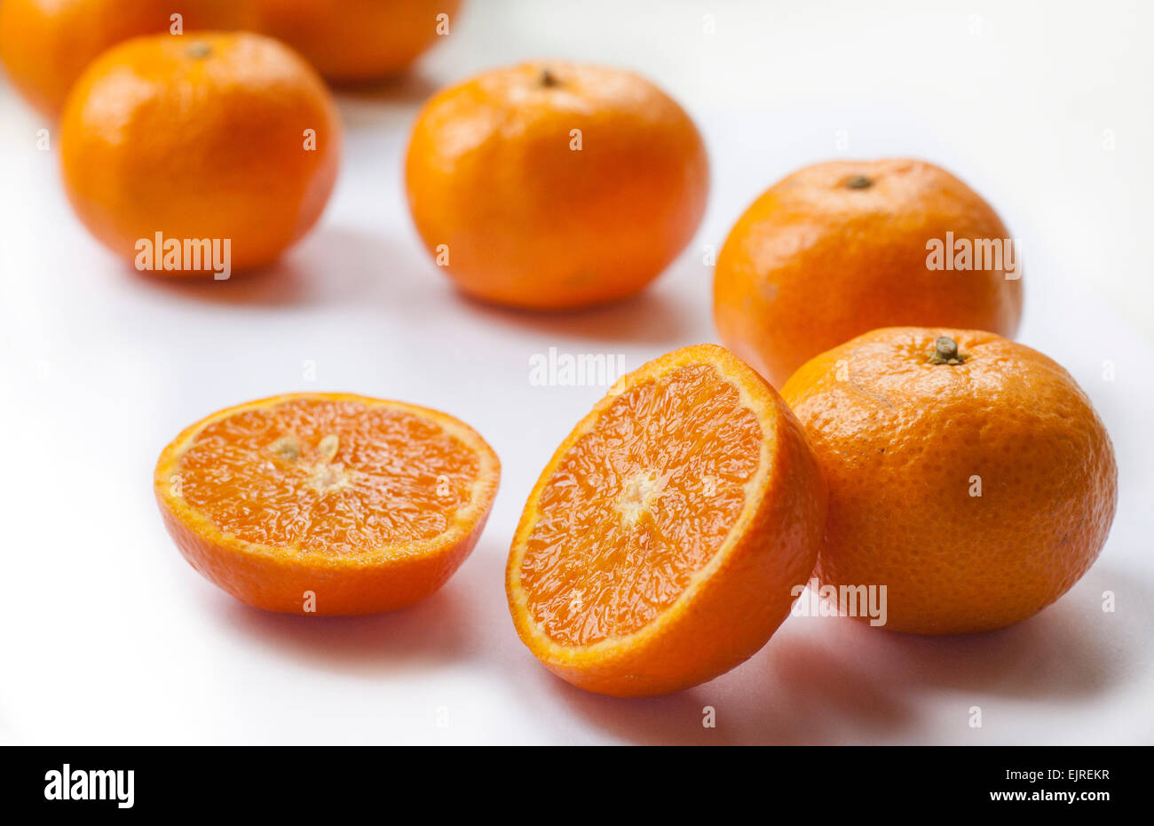 a group of fresh oranges on a clean white background Stock Photo - Alamy