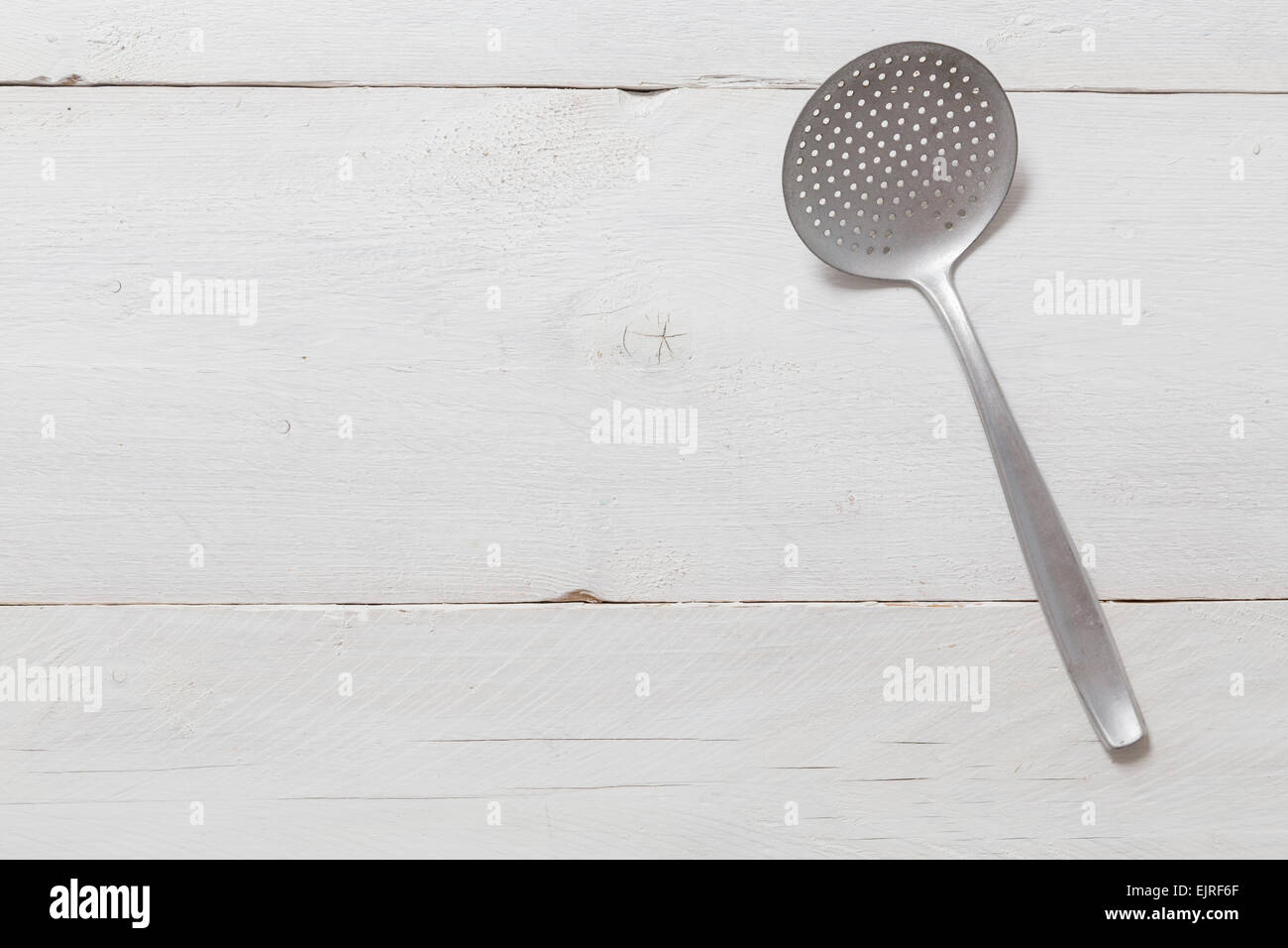 slotted spoon on rustic wood background in bird's eye view Stock Photo ...