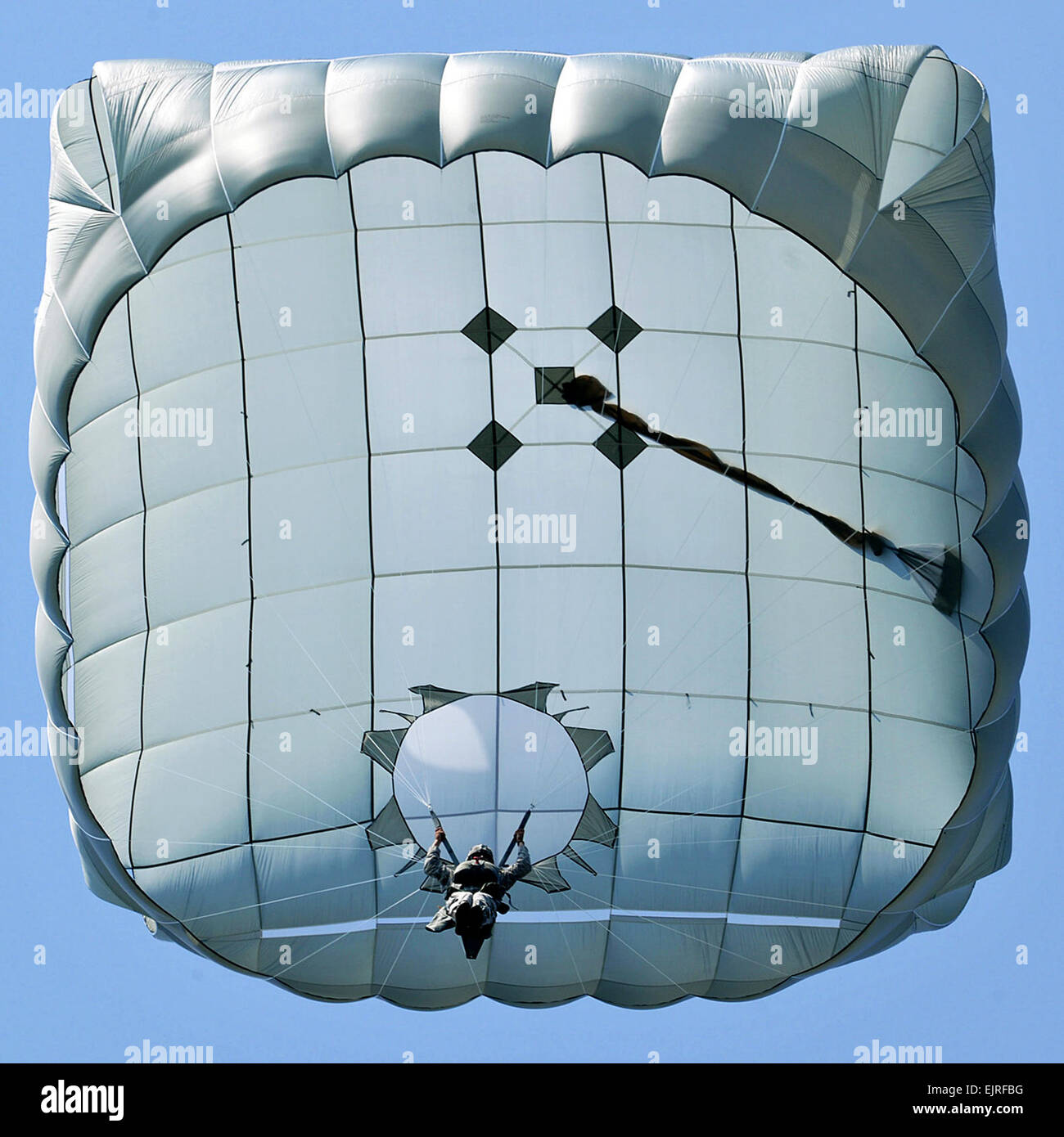 A U.S. paratrooper descends to the drop zone after exiting from a CH-47 ...