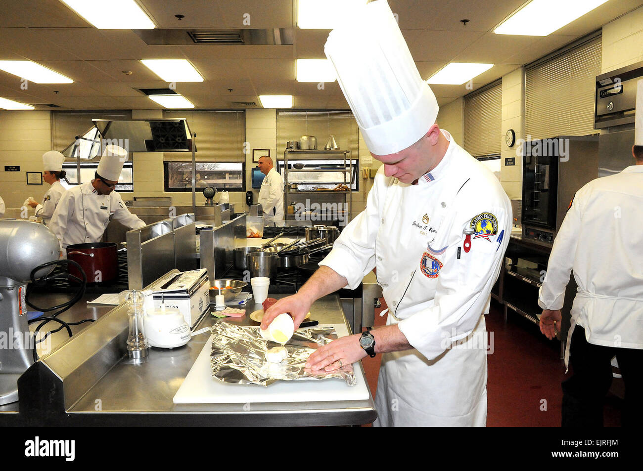 Fort Monroe's Staff Sgt. Joshua Spiess prepares a head of garlic while ...