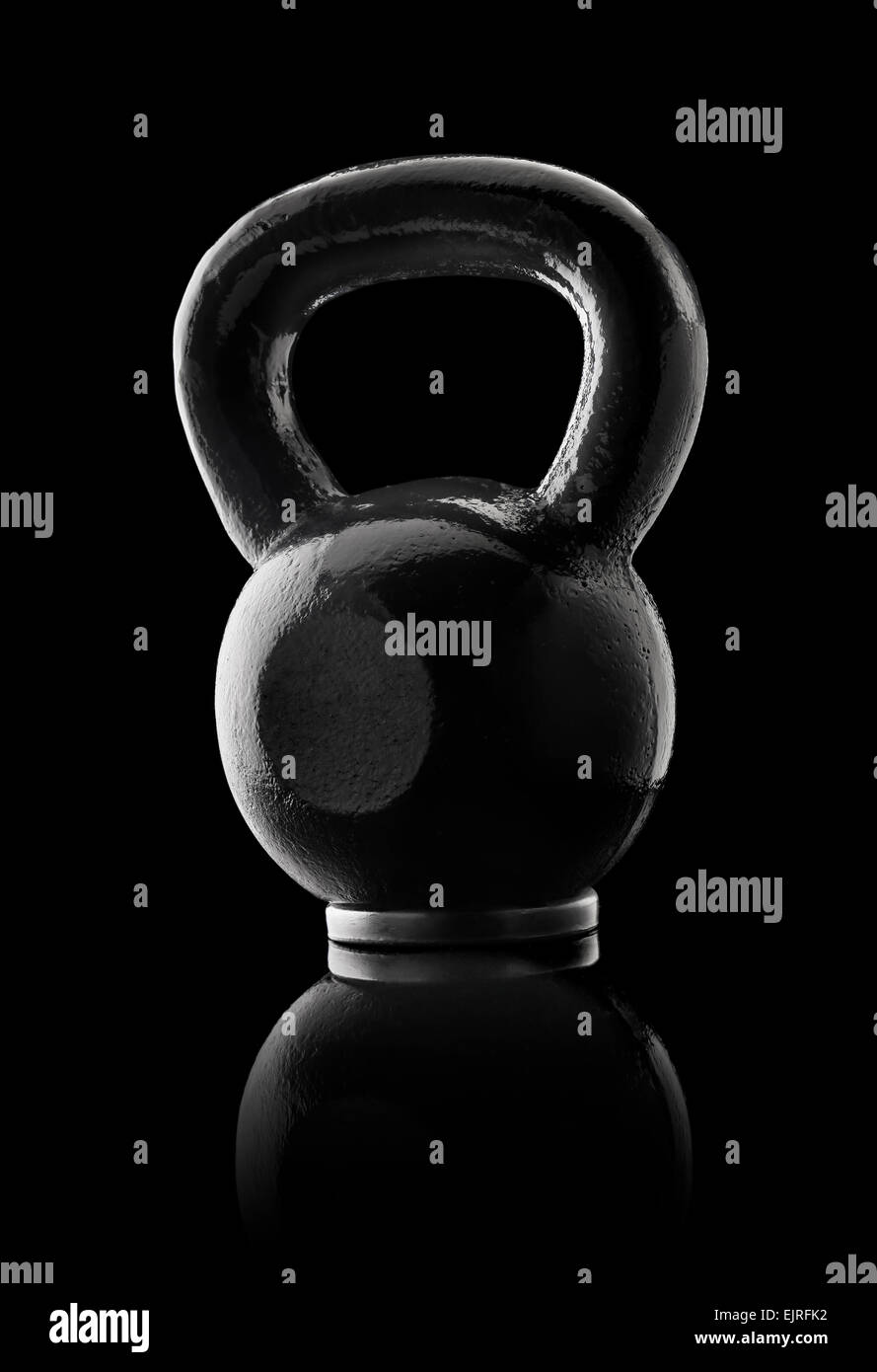 Black metallic kettlebell on black reflective background Stock Photo ...