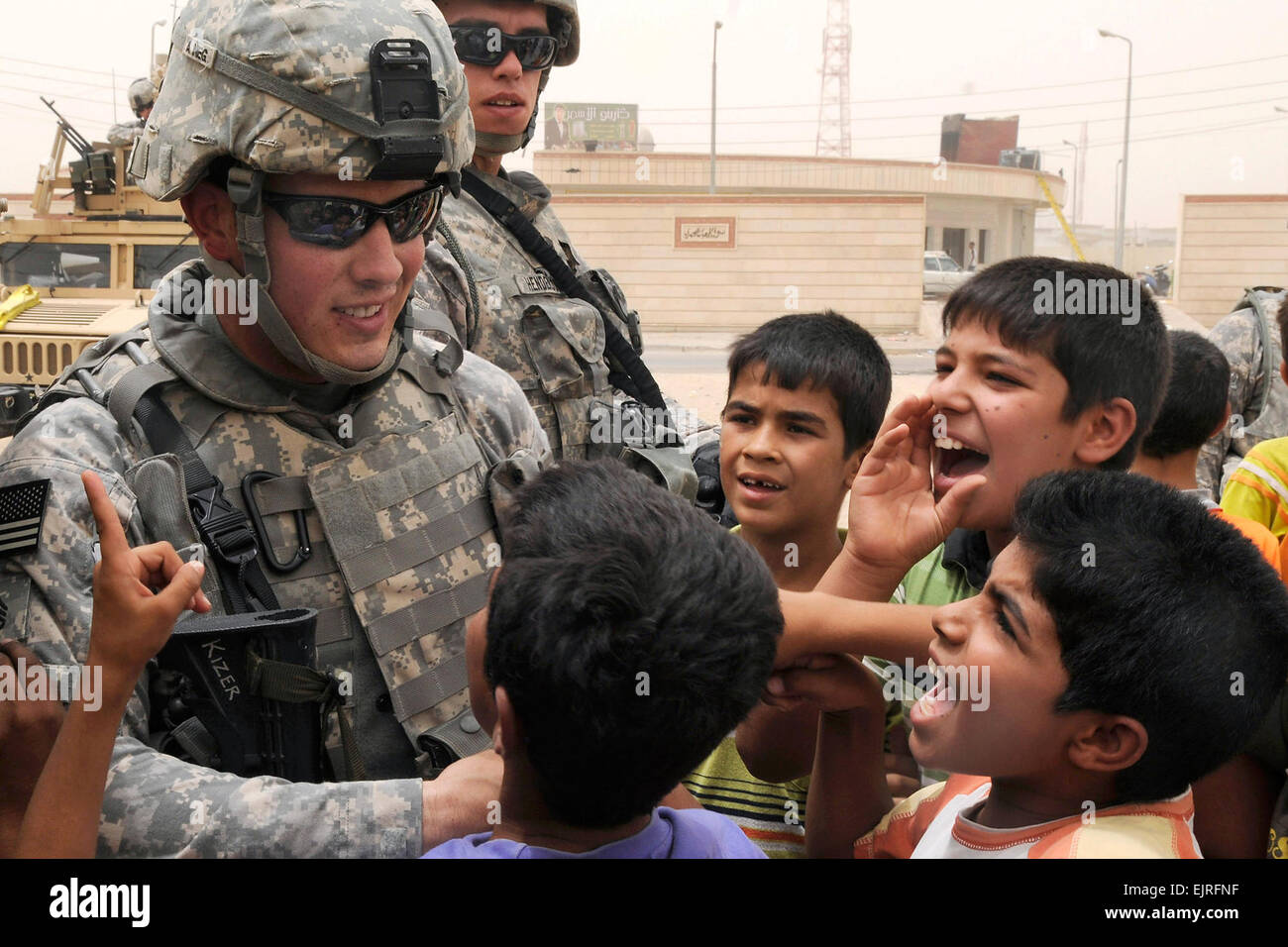 U.S. Army Staff Sgt. Victor Kizer passes out toys to local Iraqi ...