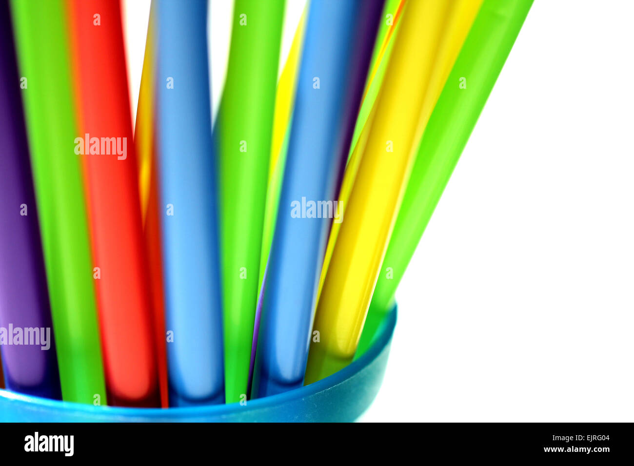 Bright multi-colored plastic straws are grouped together and placed in ...