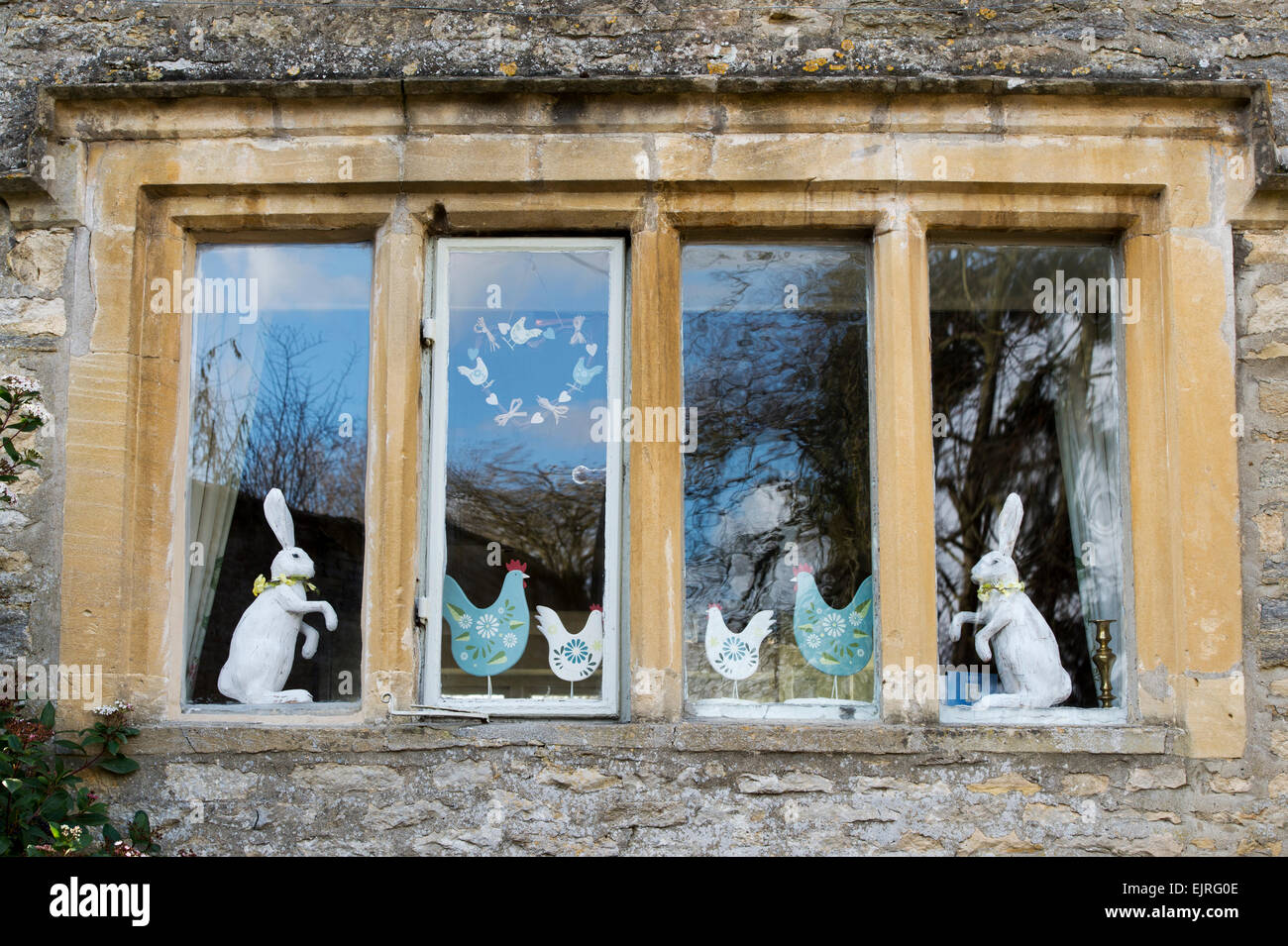 Easter Rabbits and chicken ornaments standing in a cottage window in ...