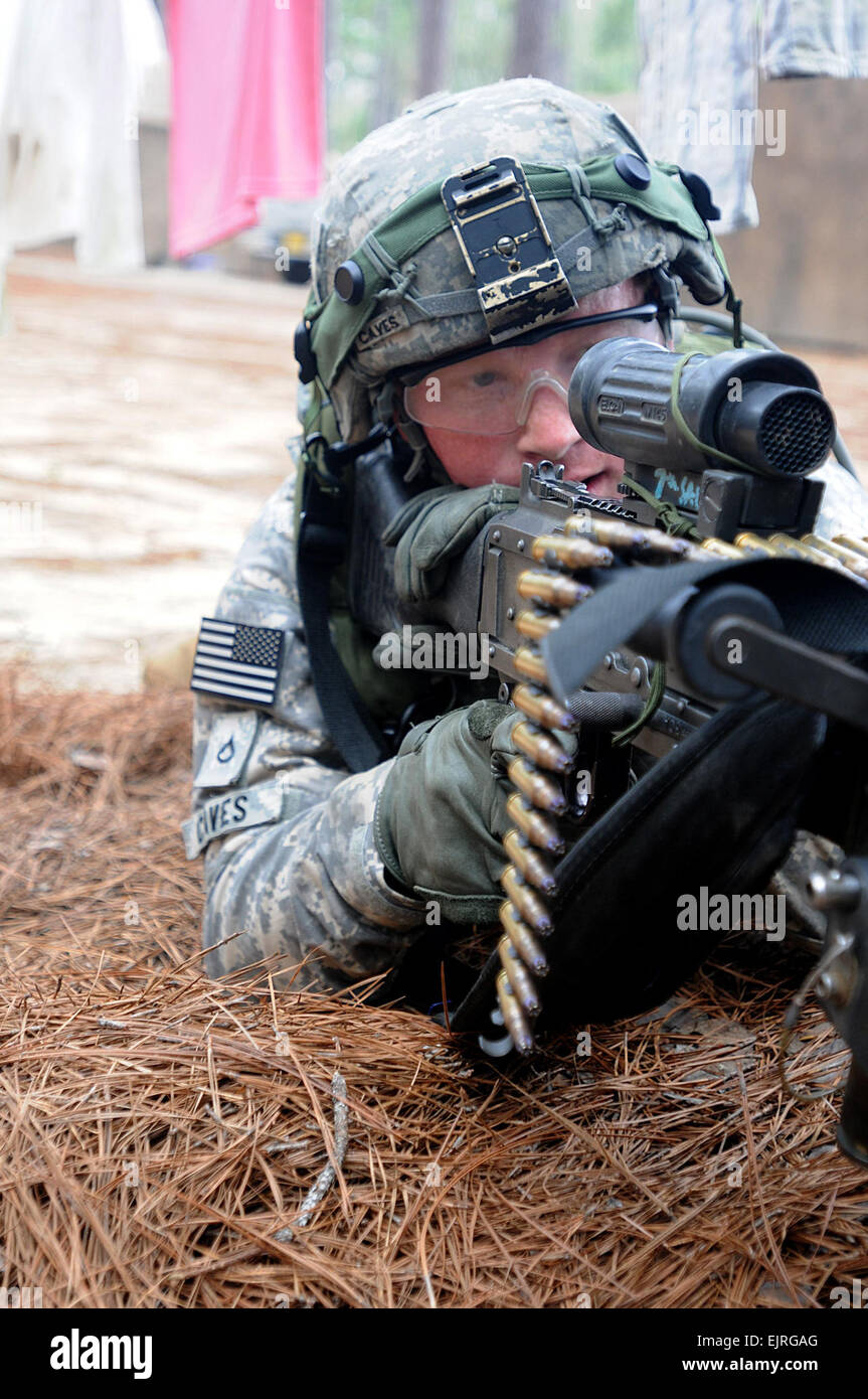 Looking through the sight of his 240B machine gun, a paratrooper with ...