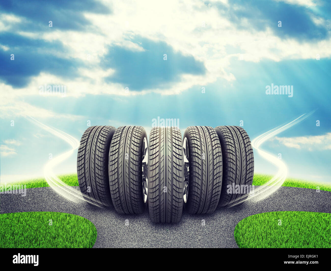 Wedge of new car wheels on road fork and green grass field Stock Photo ...