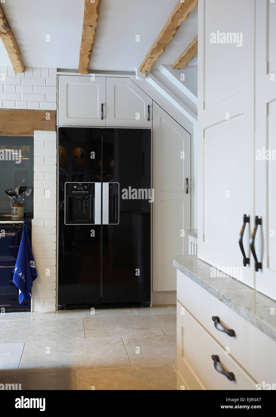 A black fridge in a traditional style kitchen inside a farmhouse in the ...