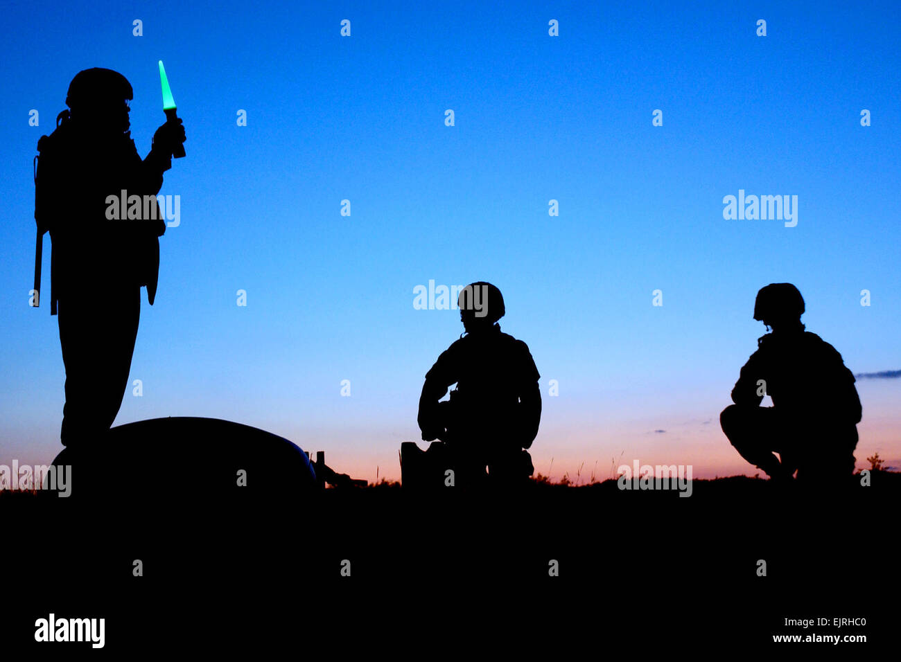 A U.S. Army Soldier holds up a green flashlight to signify the range is ...