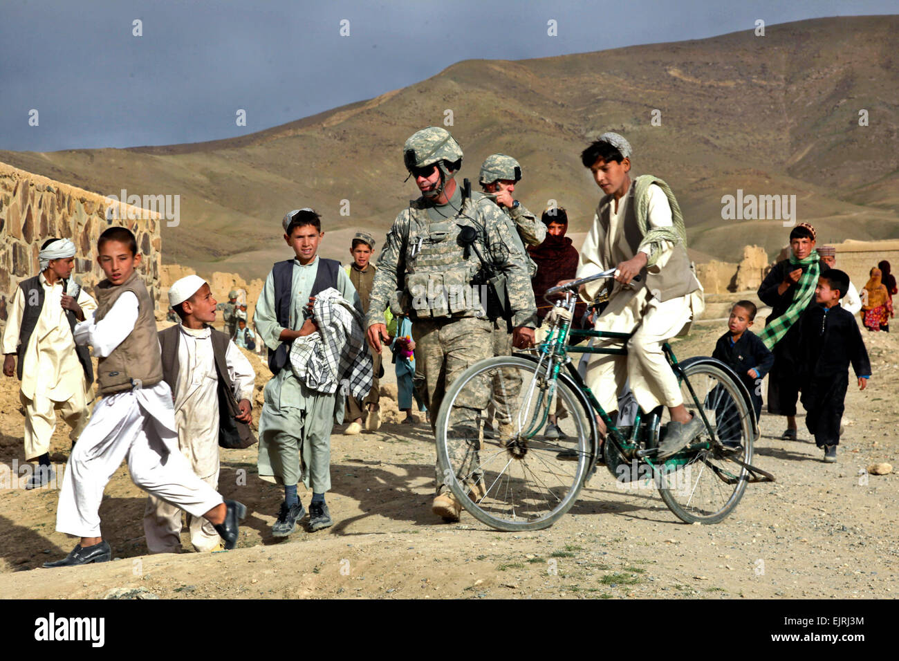 U.S. Army Soldiers walk with Afghan children through the village of ...