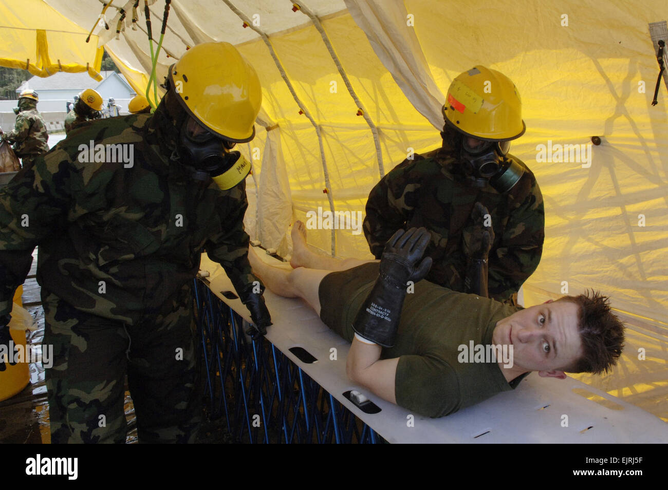 A simulated victim of a chemical attack is decontaminated by members of ...