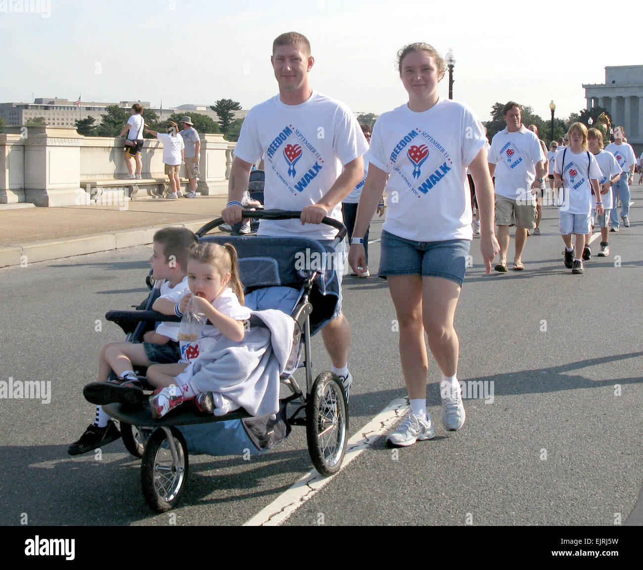 Army Sgt. Larry Miller walks across Memorial Bridge with his wife Holly ...