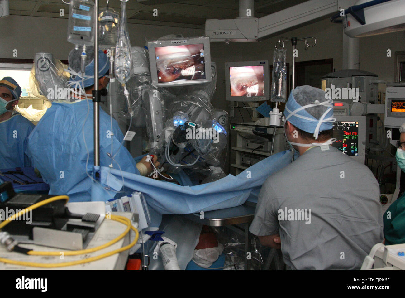 Surgeons at WRAMC perform surgery using a robotic system. While one ...
