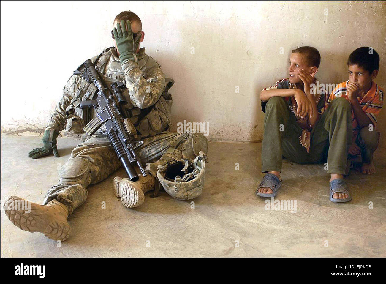 A U.S. Army soldier plays with Iraqi children during a patrol in Balad ...