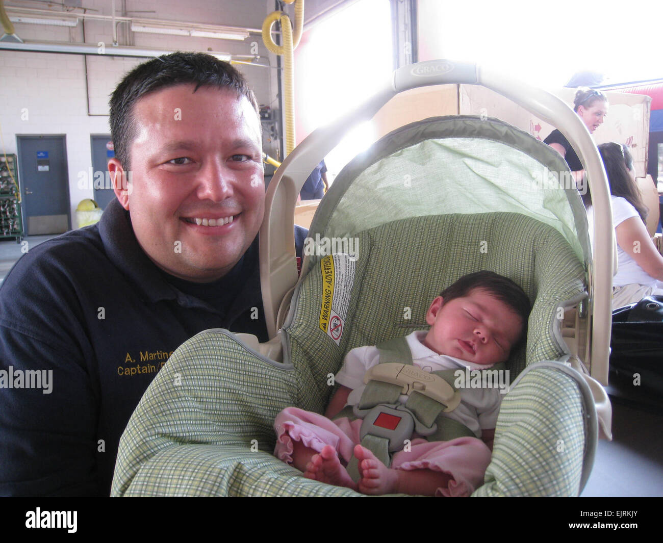 Capt. Adam Martinez and baby Amber Smith pose together for the first ...
