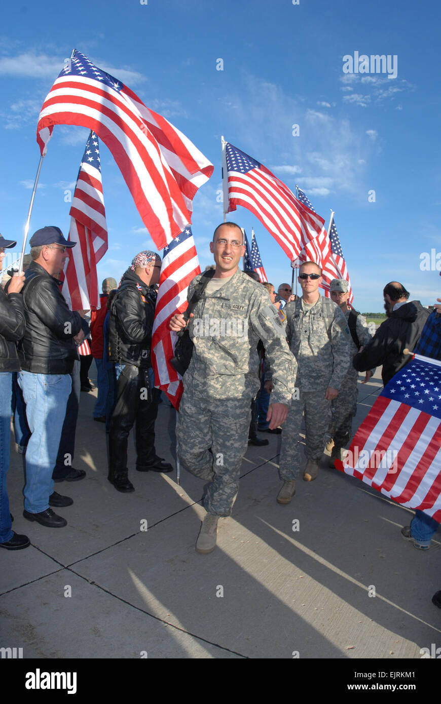 Patriot Guard Riders hold up U.S. flags to welcome back U.S. Army ...