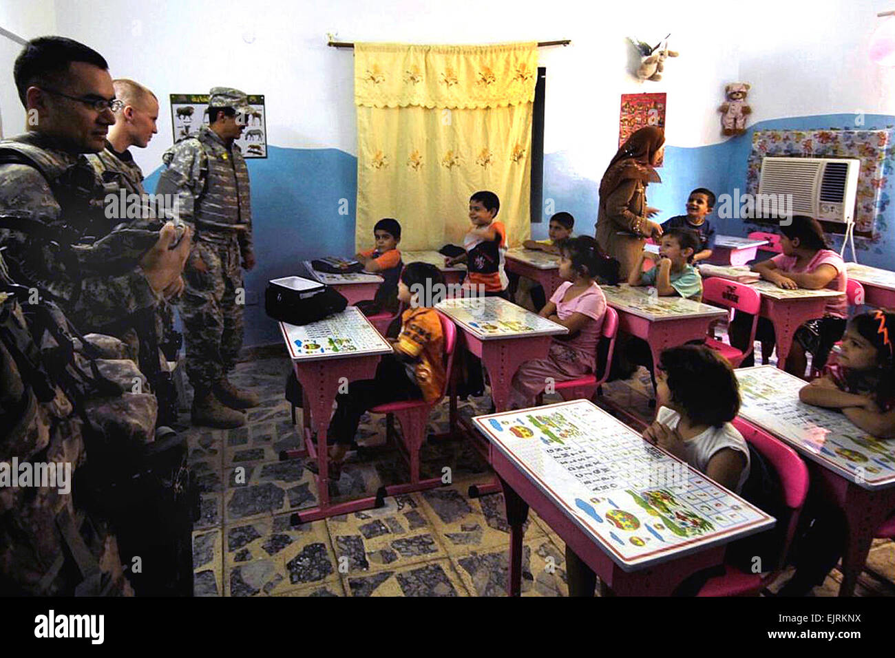 U.S. Army soldiers visit children in a classroom at Alethar Elementary ...