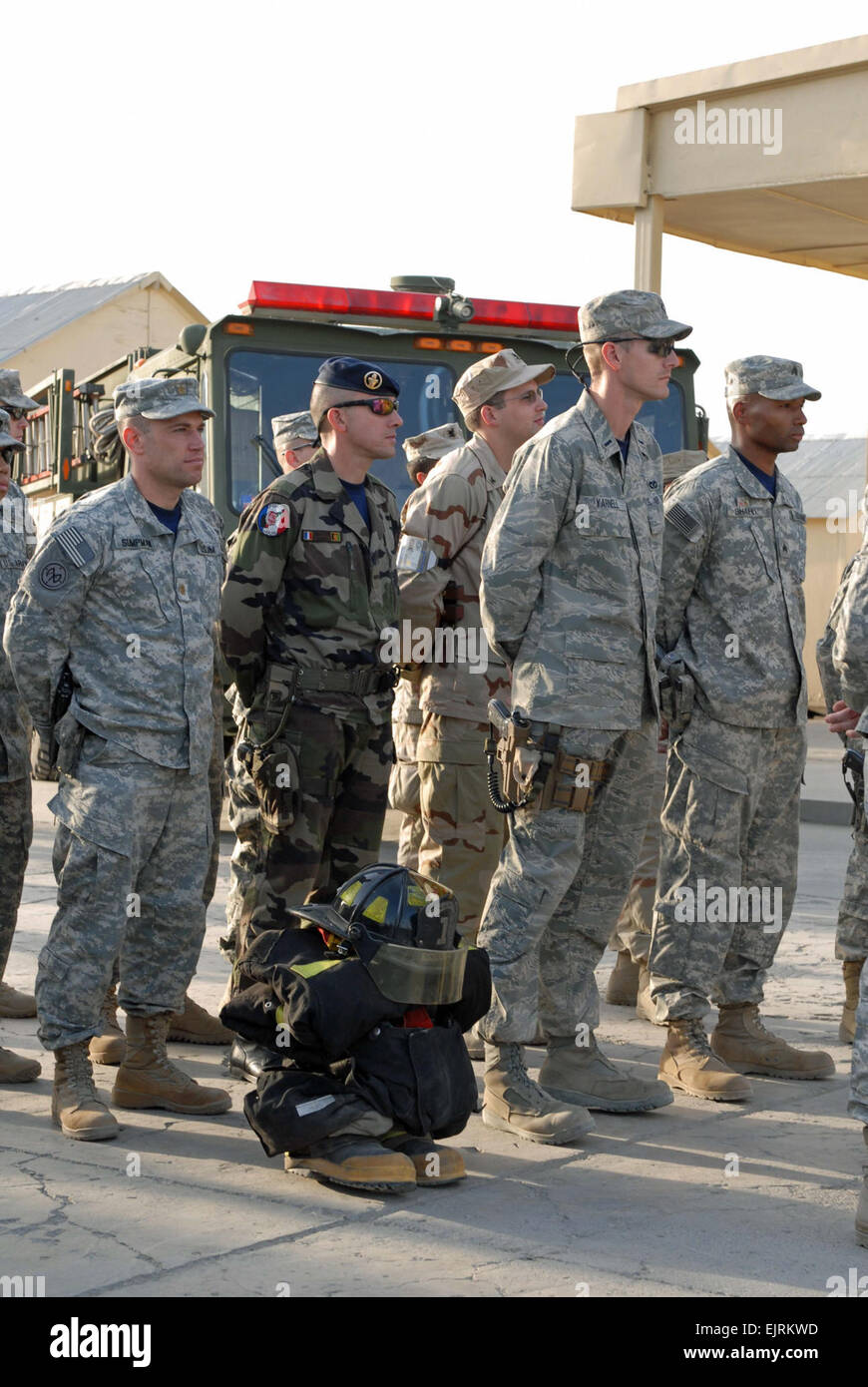 An empty firefighter’s uniform and equipment amid a formation of joint ...