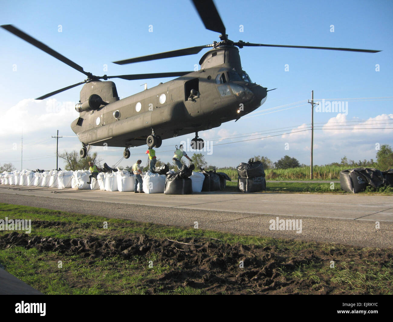 Sandbags weighing 4,000 pounds each are hooked to an Army National ...
