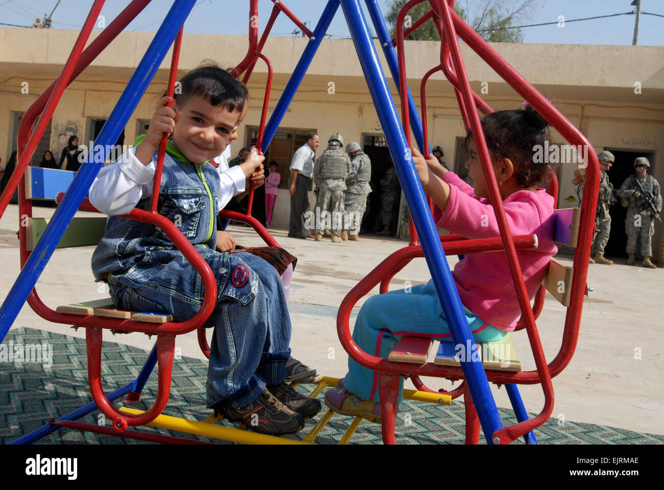 FORWARD OPERATING BASE FALCON, Iraq - Two Iraqi children enjoy a new ...