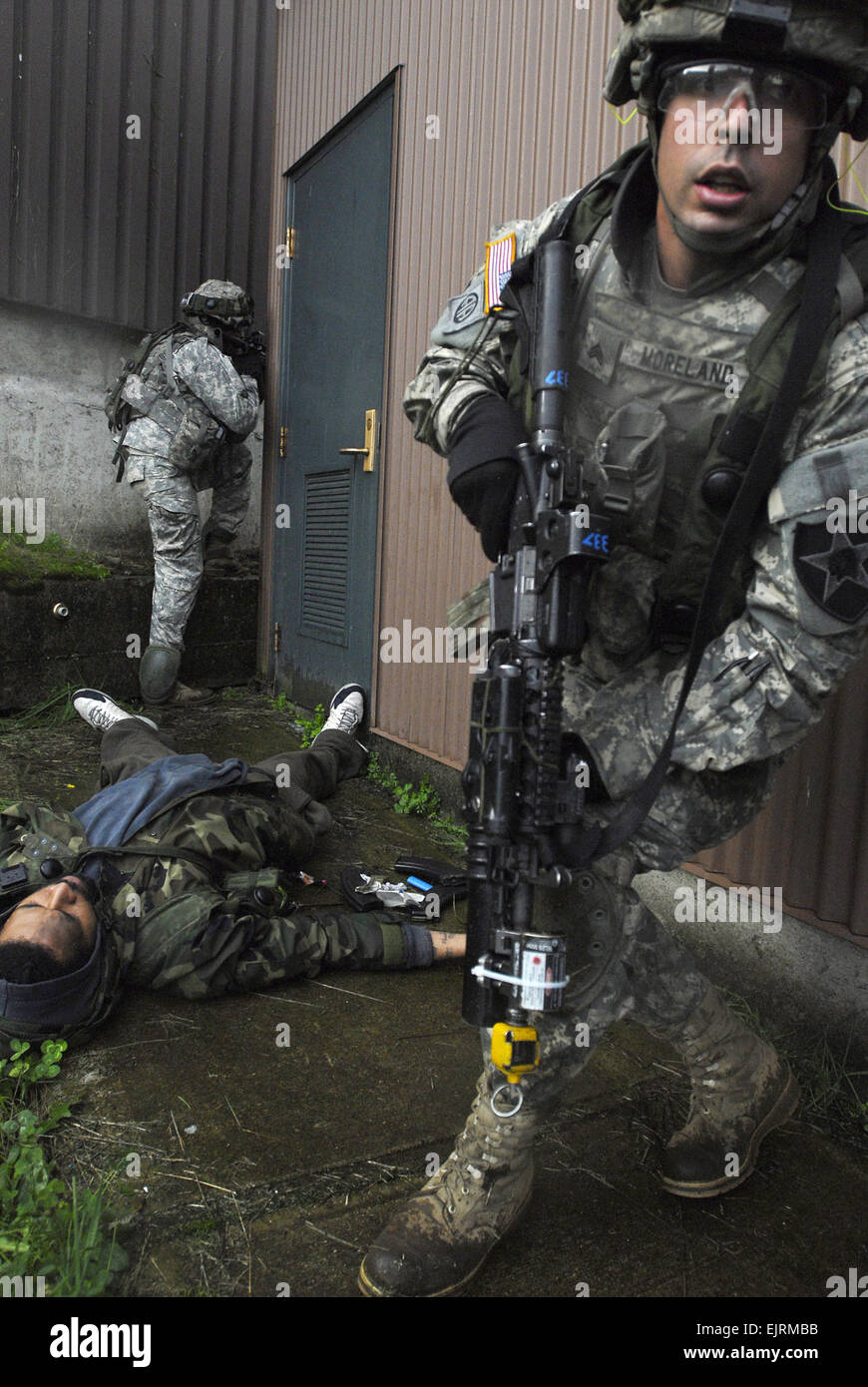Sgt. Roy Moreland from 1-23 Inf. stands next to a fallen enemy ...