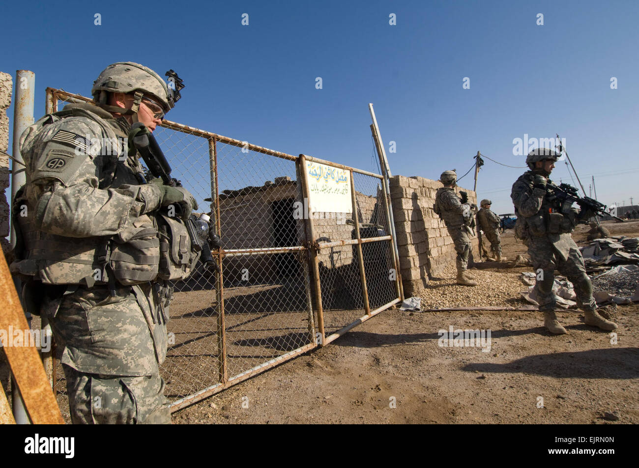 Staff Sgt. Justin Nellums left pulls security at an Iraqi police ...