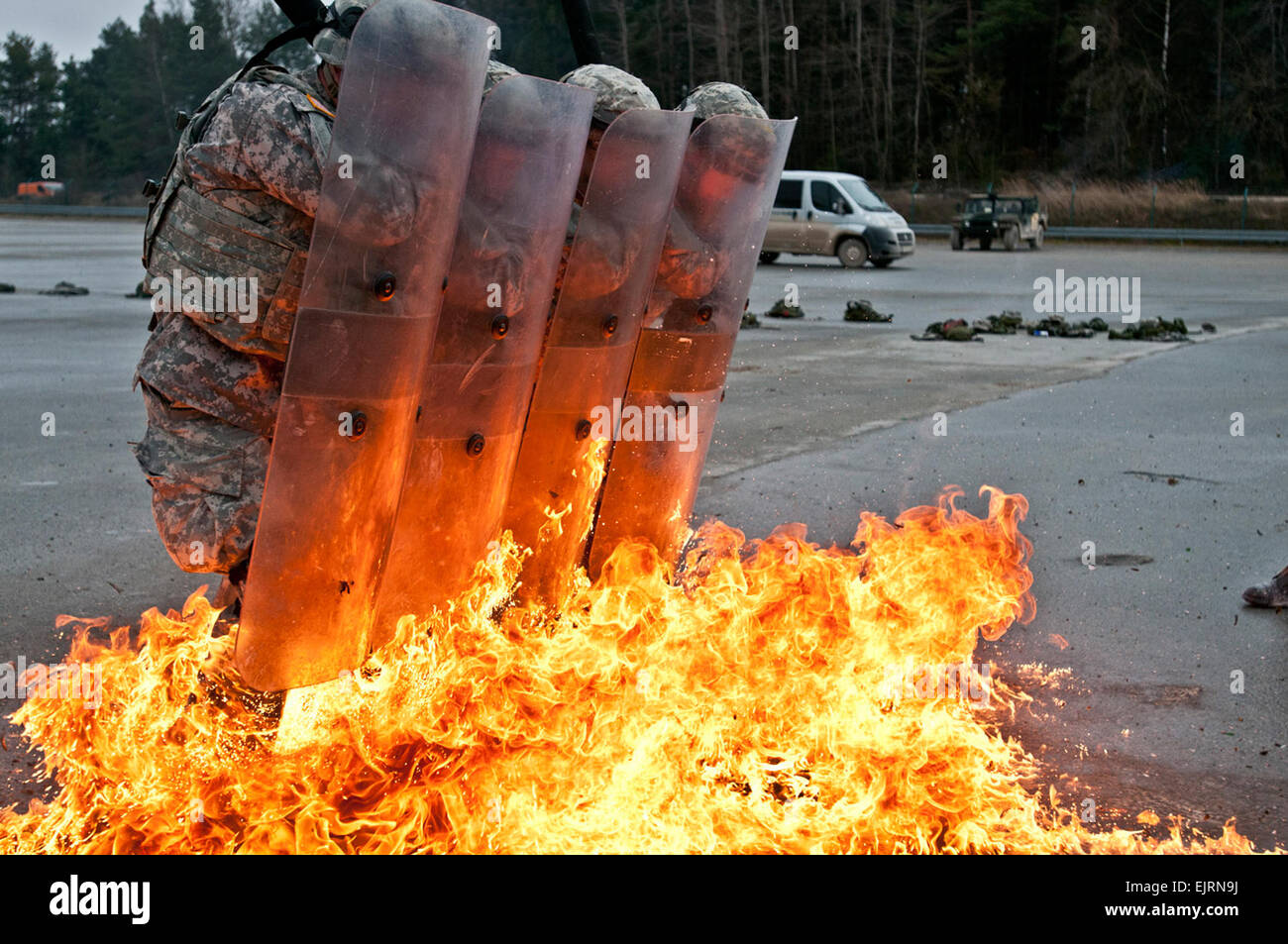 HOHENFELS, Germany – A wave of fire crashes against the riot shields of ...