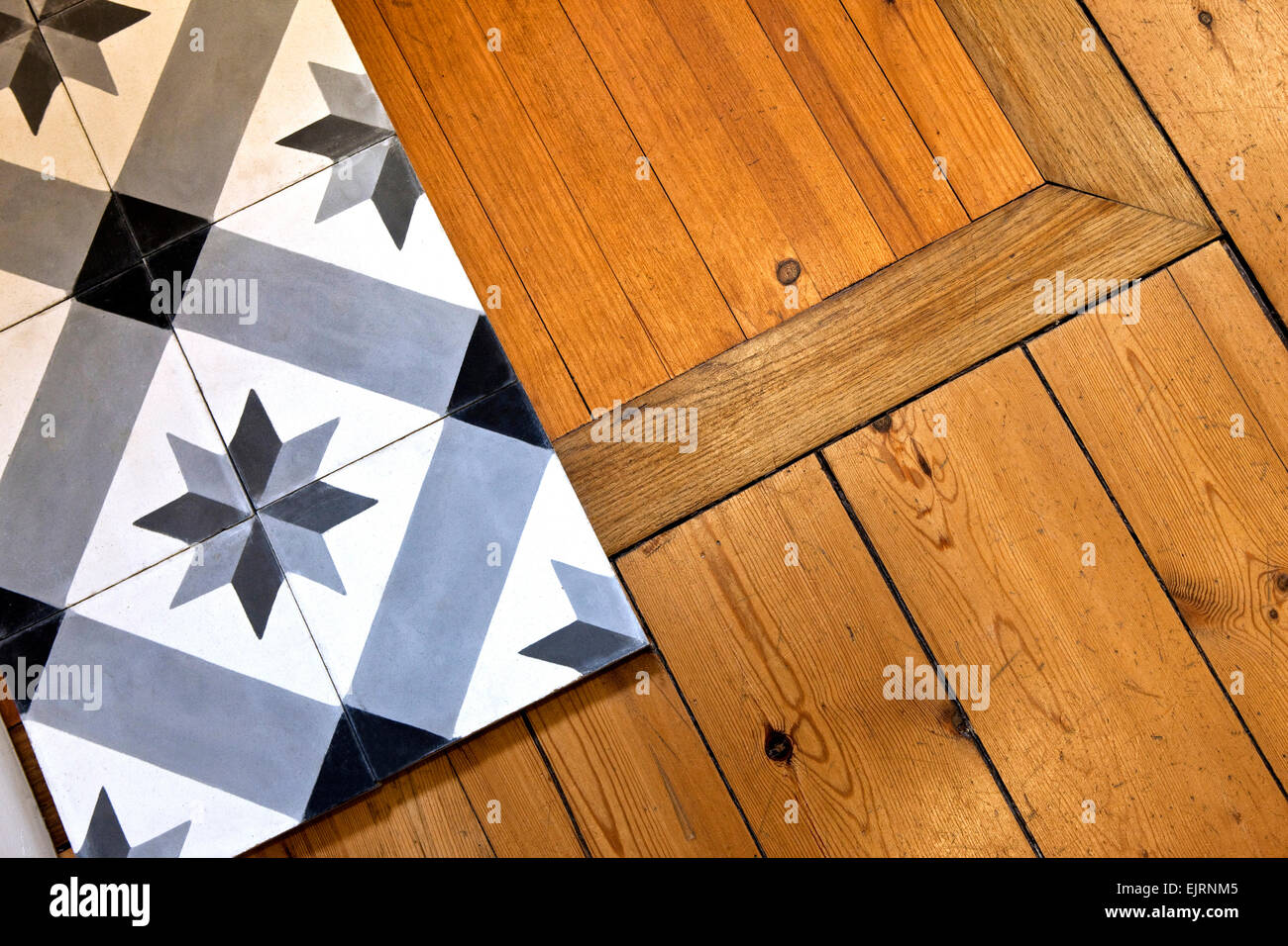 Stylish tiles on a wooden floor inside a house Stock Photo - Alamy