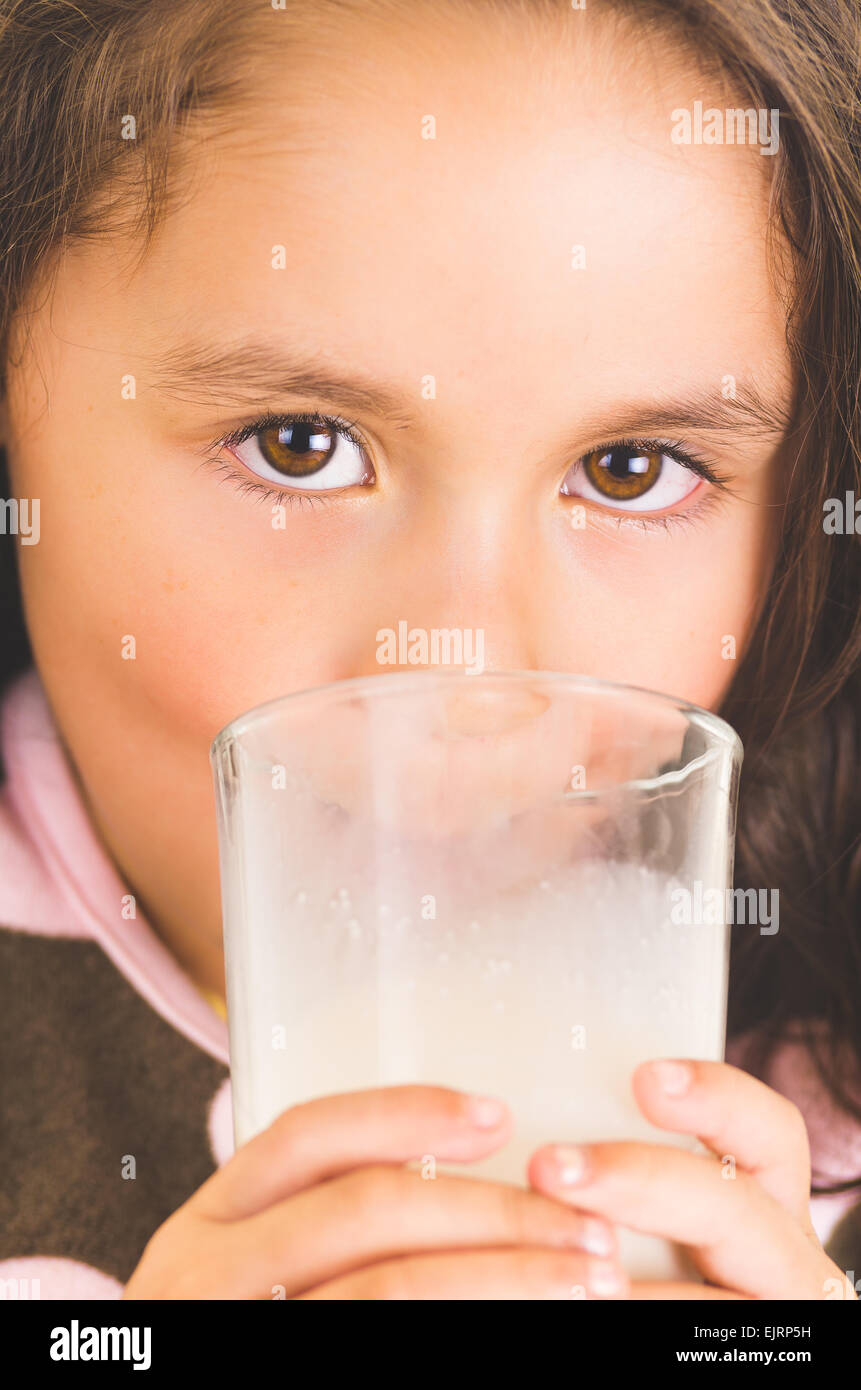 Cute little preschooler girl drinking a glass of milk Stock Photo - Alamy
