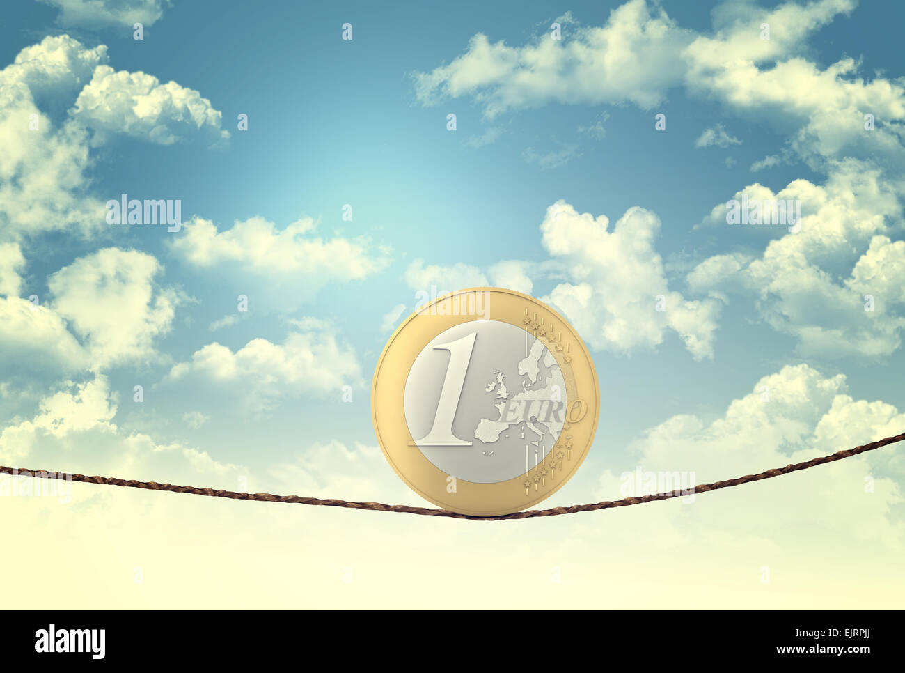 euro coin balance on rope Stock Photo - Alamy