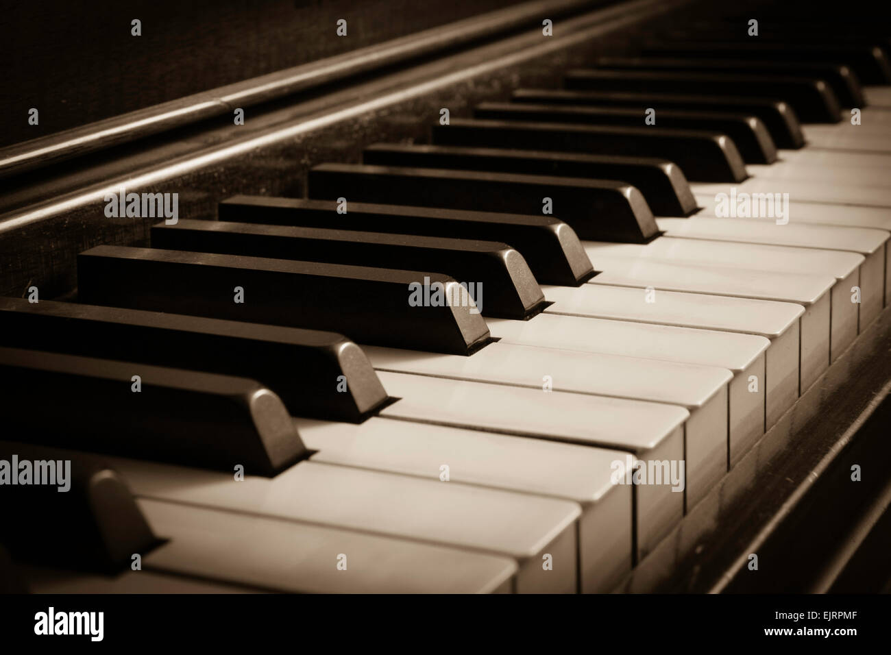 A unique perspective of piano keys on an old piano; sepia colortone ...