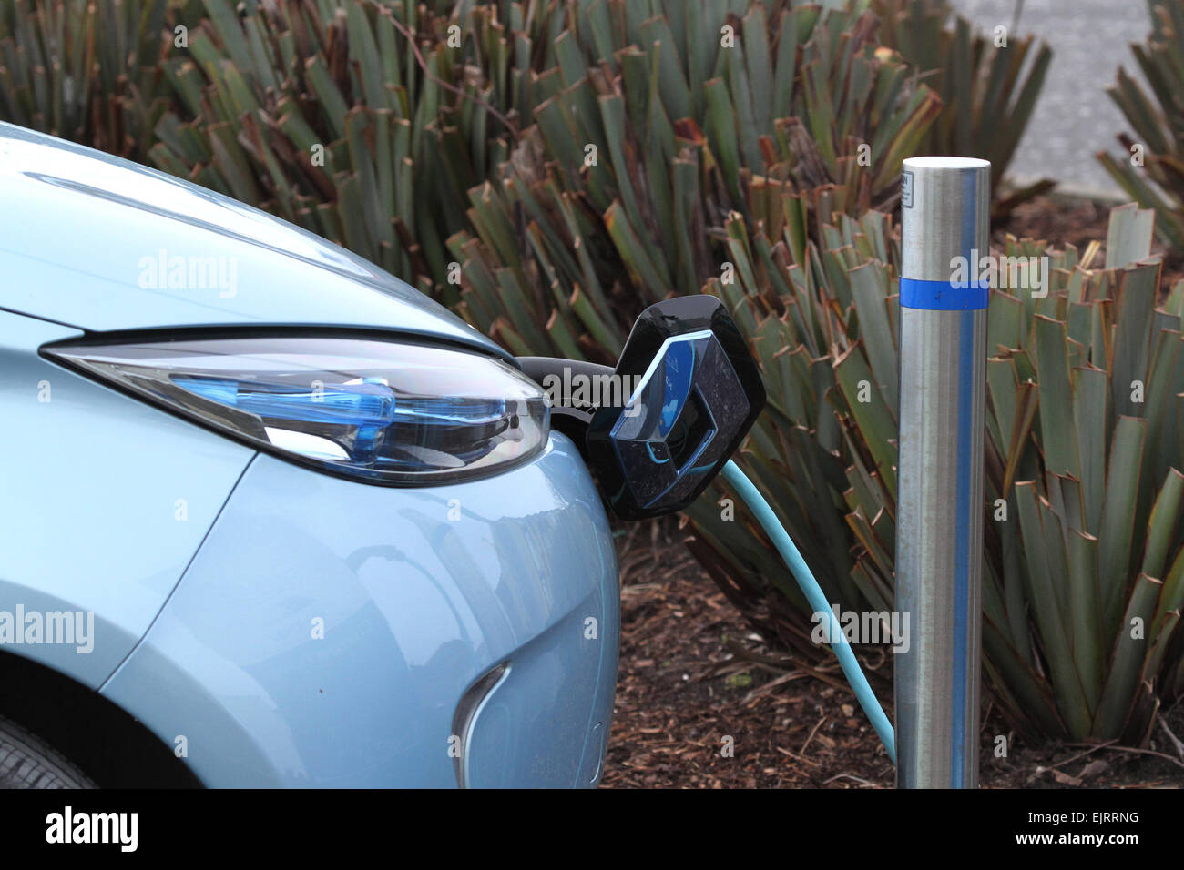 Electric car being charged Stock Photo - Alamy