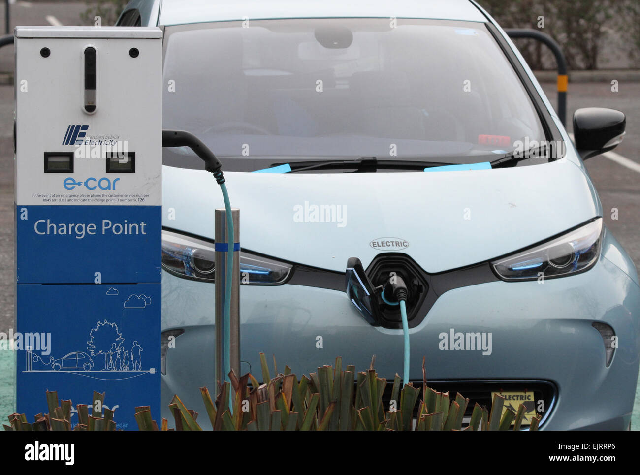 Electric car being charged at charge point Stock Photo - Alamy