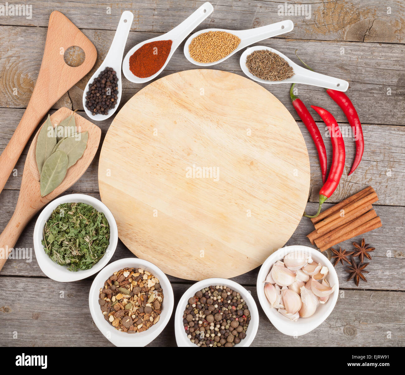 Herbs and spices on wood table background with blank cutting board for ...