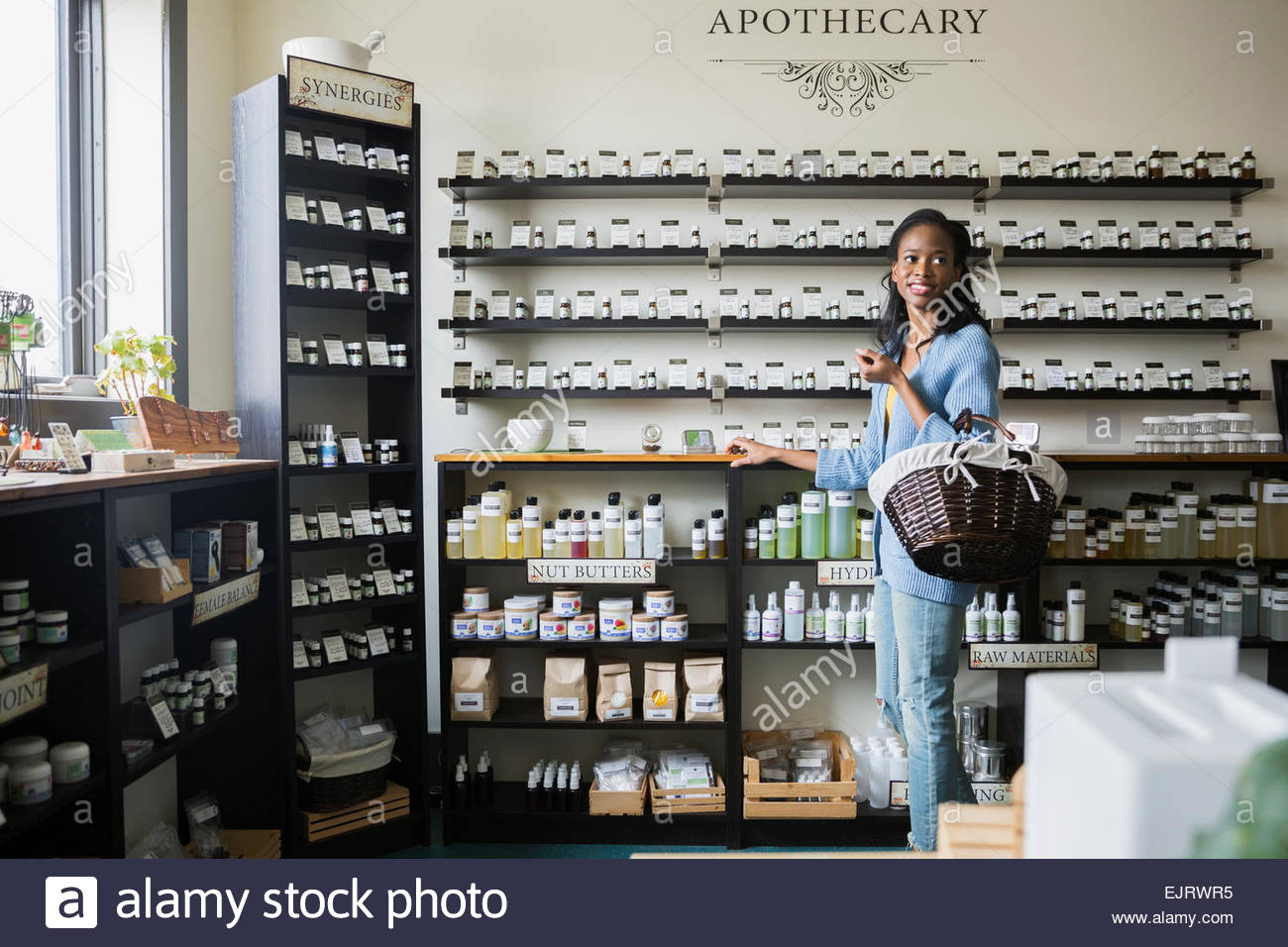 Smiling woman in apothecary shop Stock Photo - Alamy