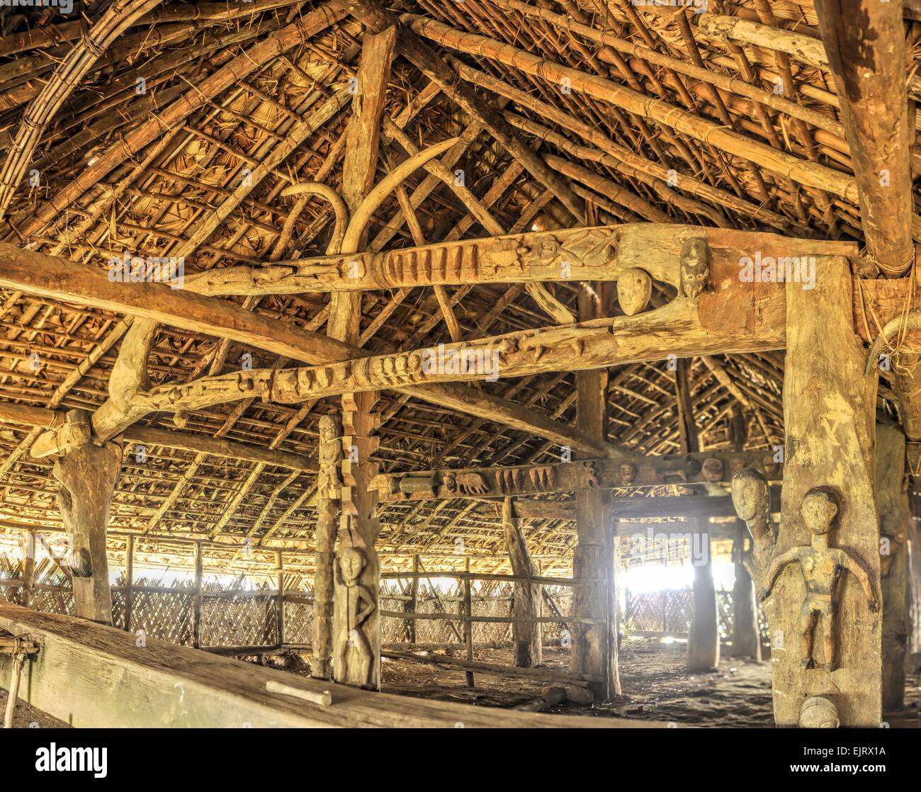 Interior of a traditional wooden dwelling with carved symbols in India ...