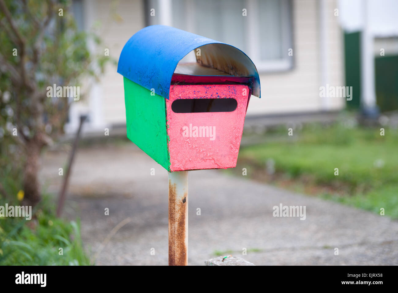 Old letterbox at end of path infront of home, rusty and painted in ...