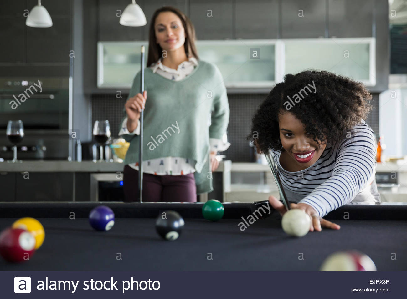 Two women shooting pool hi-res stock photography and images - Alamy