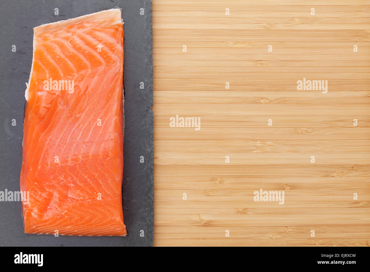 Fresh salmon fish on bamboo wooden table with copy space Stock Photo ...