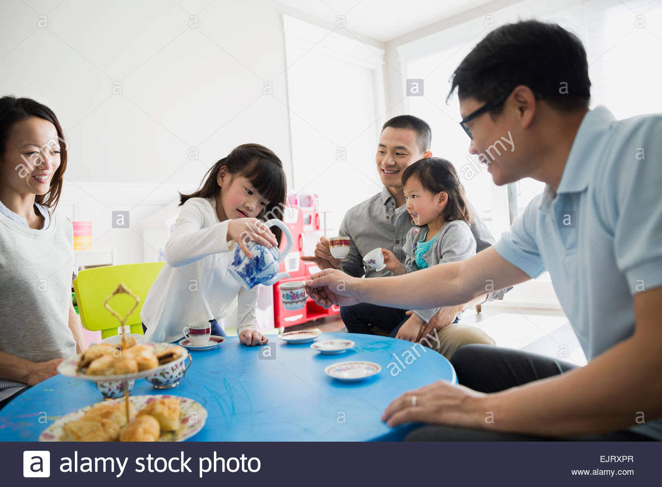 Multi-generation family enjoying tea party in playroom Stock Photo - Alamy