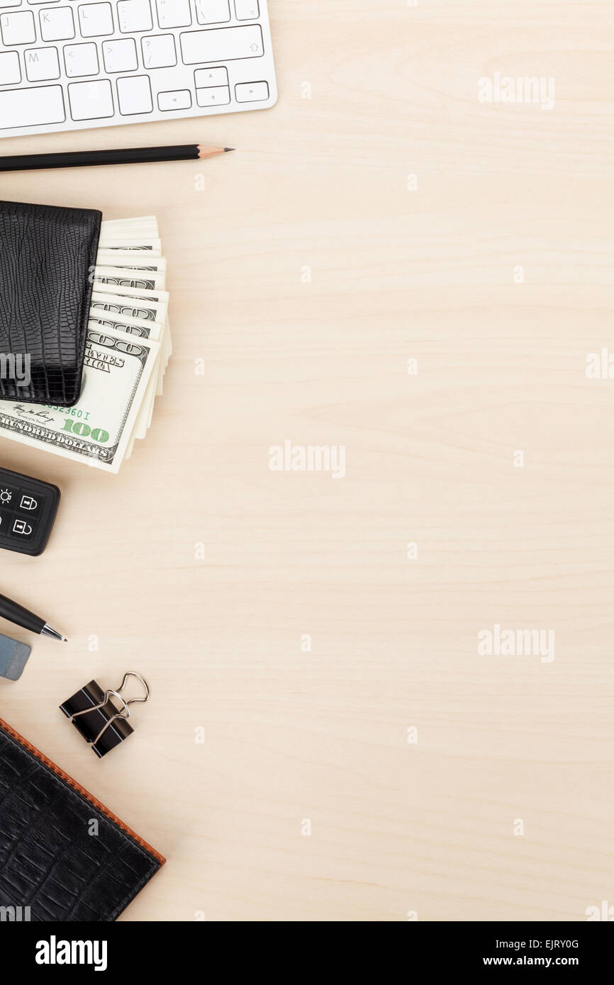 Office table with pc, supplies and money cash. View from above with ...