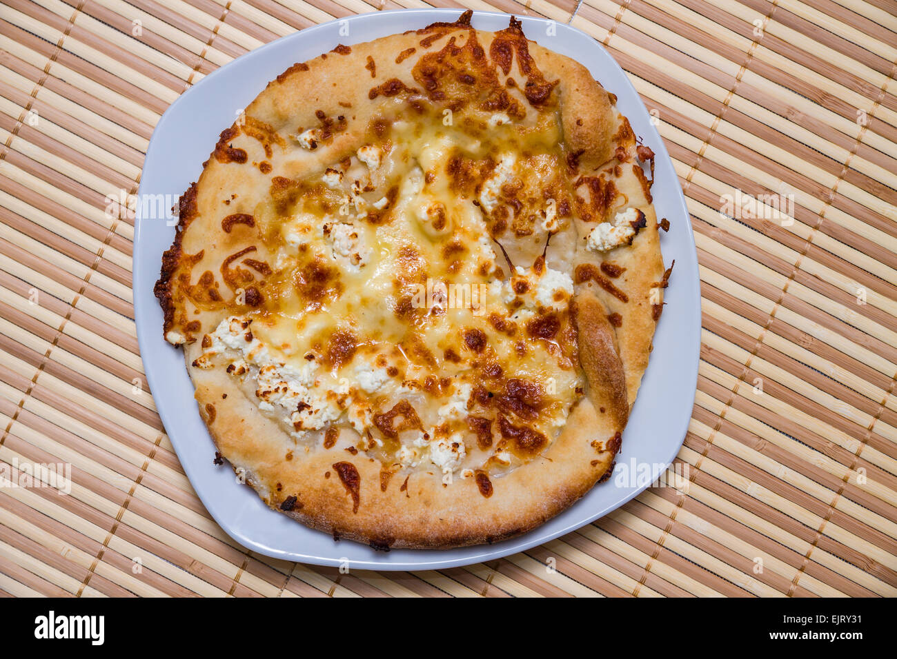 Hot Tasty bread cake with feta cheese made in fire furnace of bakery ...