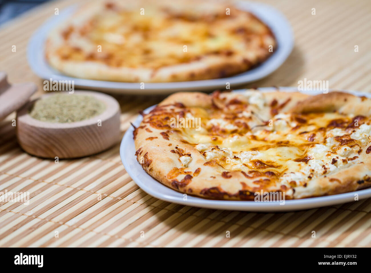 Hot Tasty bread cake with feta cheese made in fire furnace of bakery ...