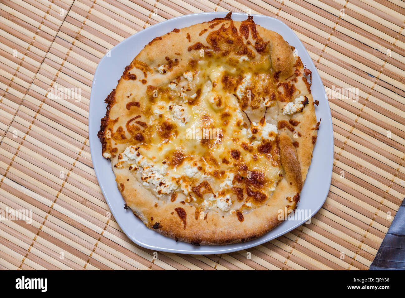 Hot Tasty bread cake with feta cheese made in fire furnace of bakery ...