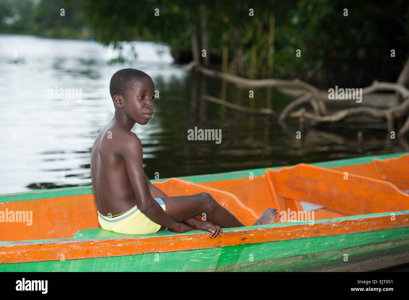 Maroon boy sitting in a boat on the Upper Suriname River, New Aurora ...