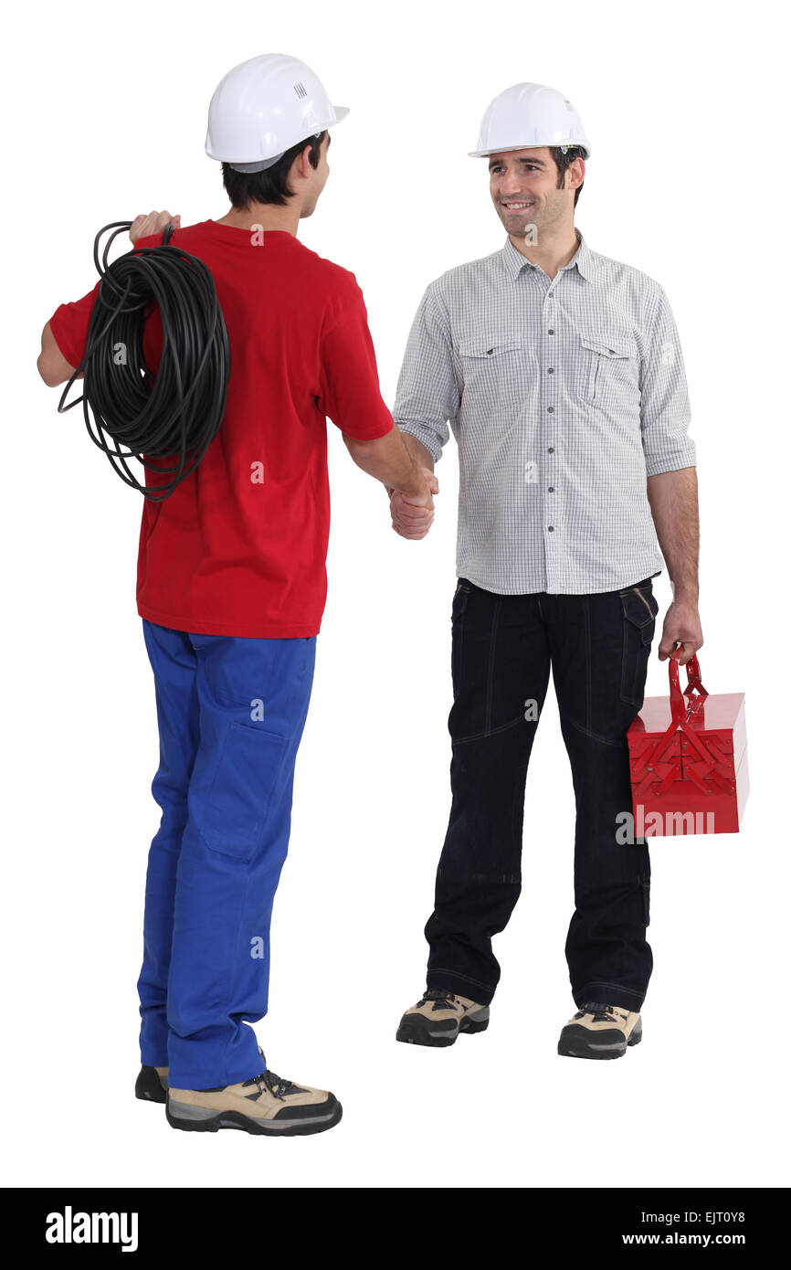 Two electricians greeting each other Stock Photo - Alamy