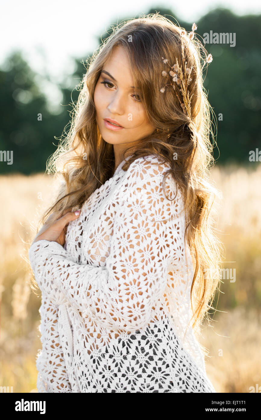 Beautiful lady model standing in open field at sunset Stock Photo - Alamy